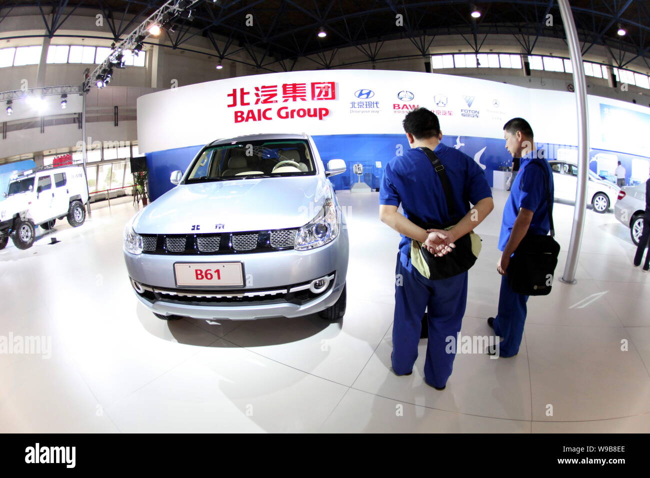 --FILE--Chinese visitors look at a B61 SUV of BAIC Group during a fair ...