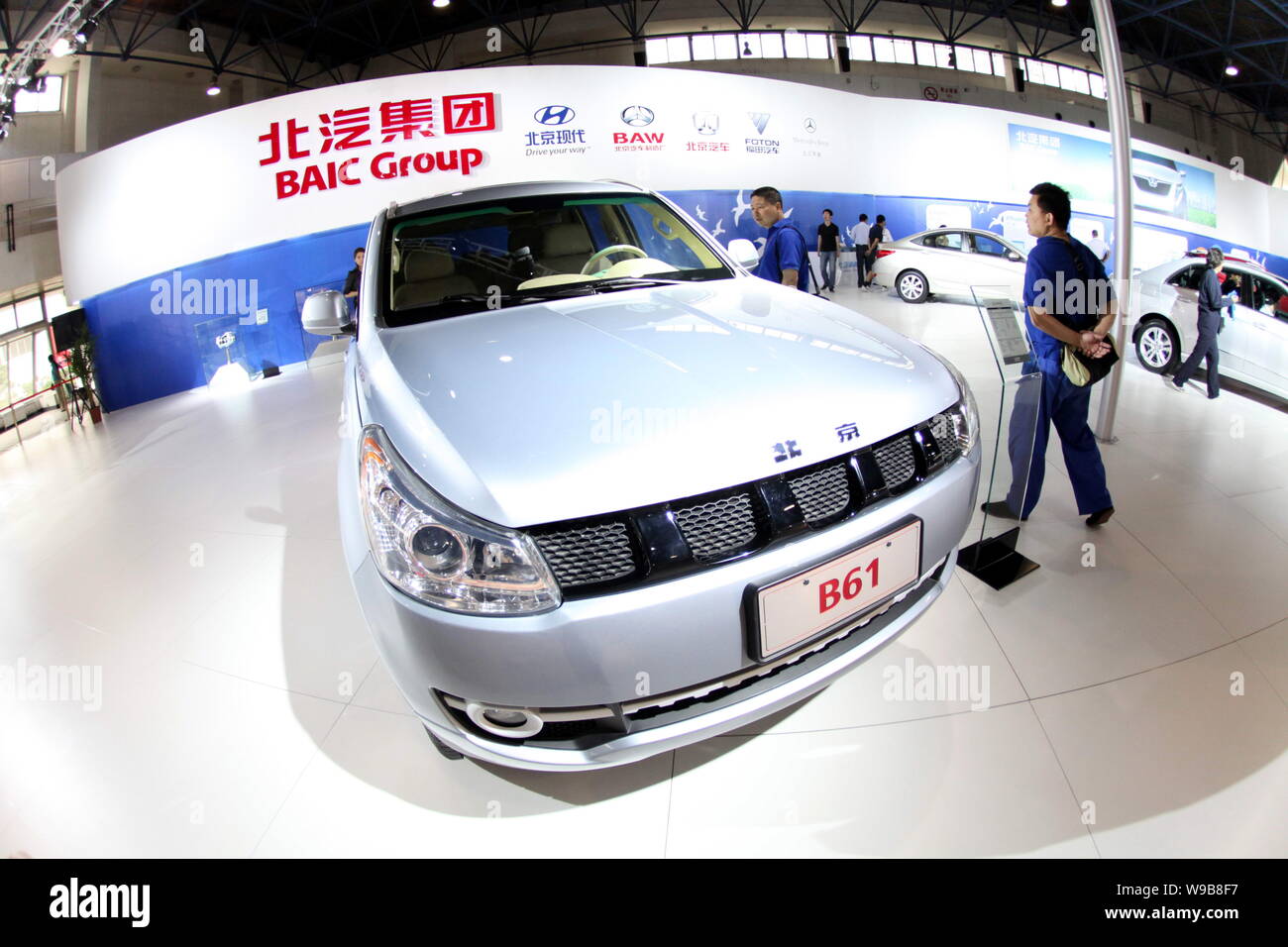 --FILE--Chinese visitors look at a B61 SUV of BAIC Group during a fair ...