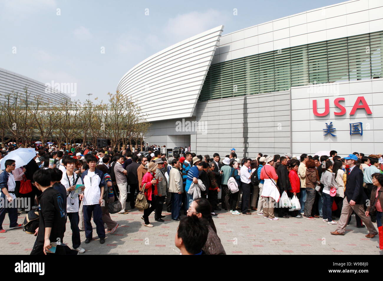 Crowds of visitors queue up to enter the USA Pavilion in the Expo site ...