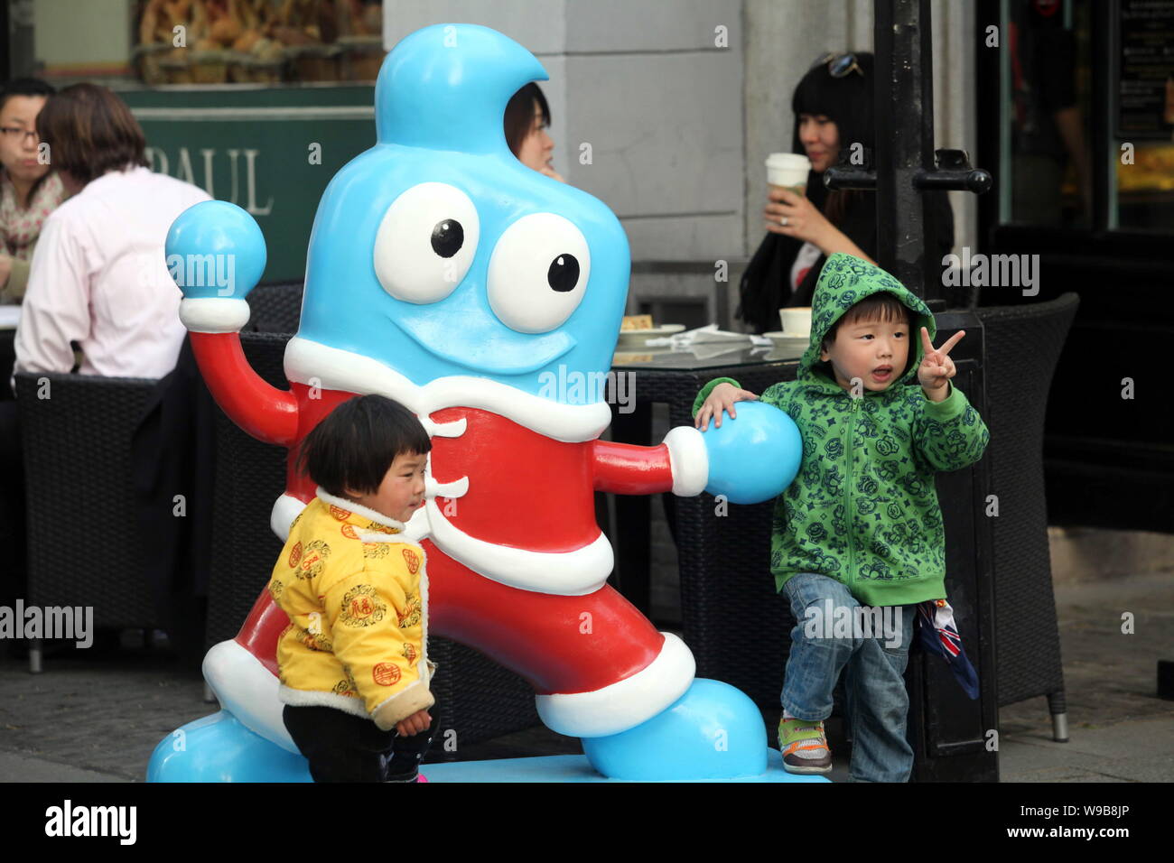 Kids pose with a Haibao figure, the official mascot of the World Expo ...
