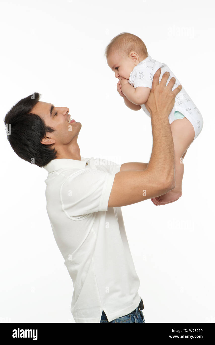 Young man playing with his baby boy Stock Photo - Alamy