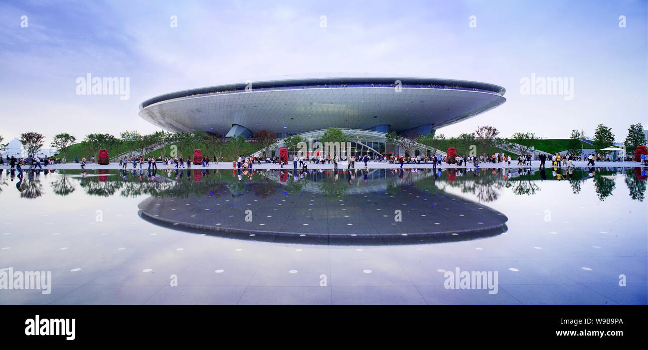 Visitors walk past the Expo Culture Center in the World Expo Park in ...