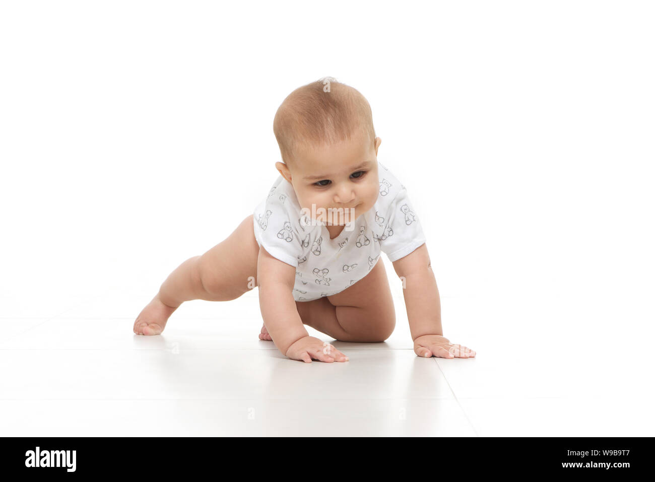 Baby boy crawling on floor Stock Photo - Alamy