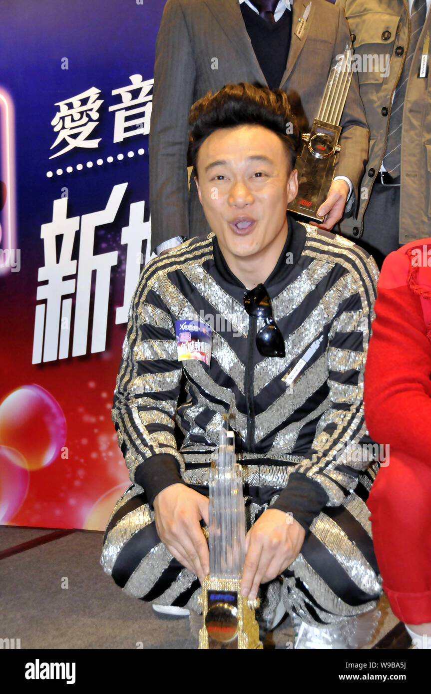 Hong Kong singer Eason Chan Yik-shun poses with his trophy after the ...
