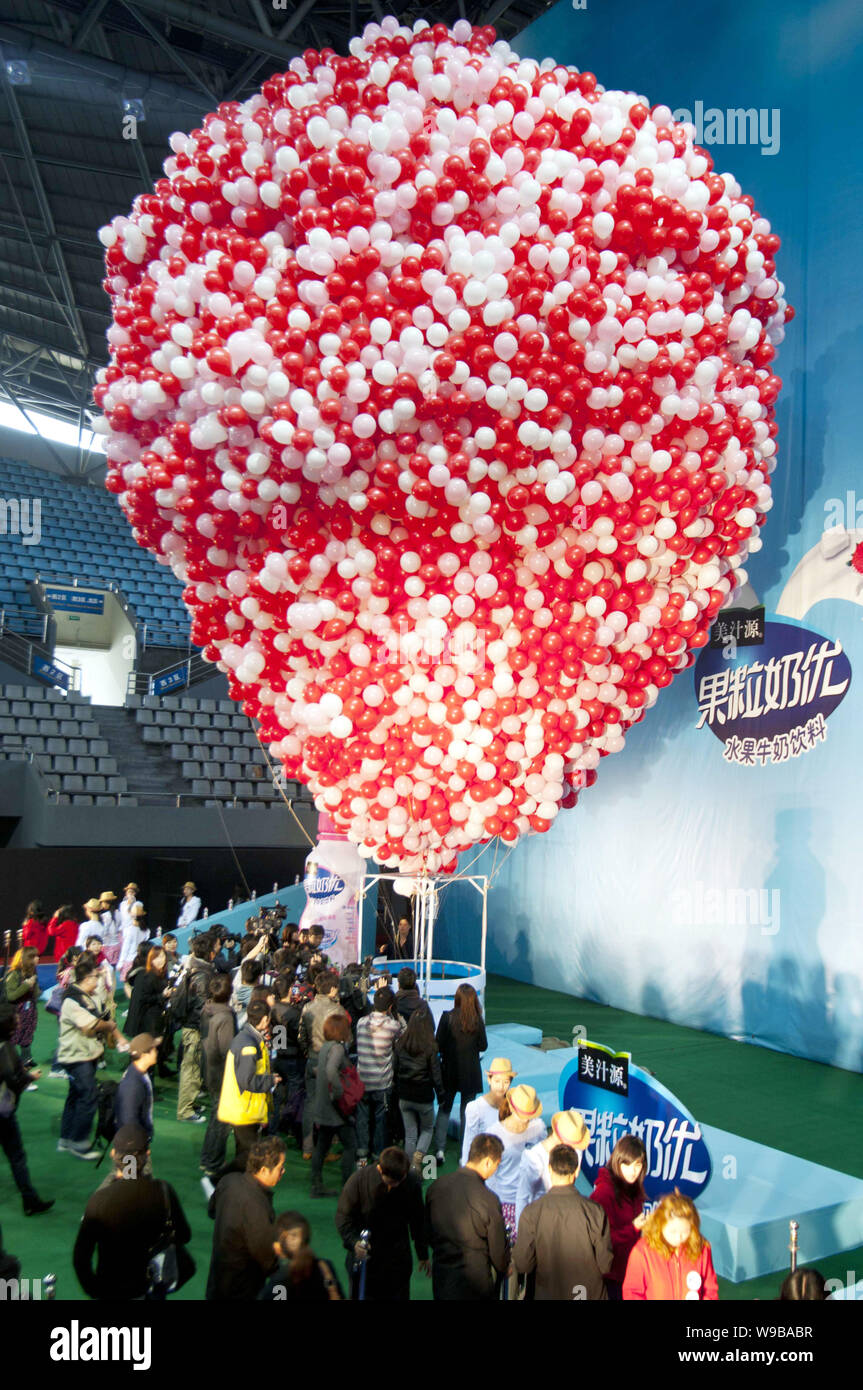 Visitors look at the largest helium balloon cluster during a ceremony ...