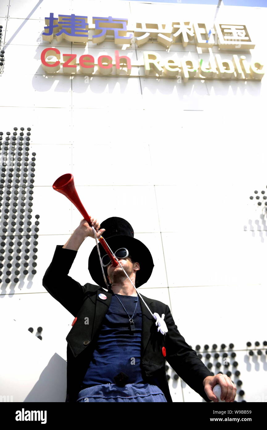 A performer trumpets in front of the Czech Pavilion in the Expo site on ...