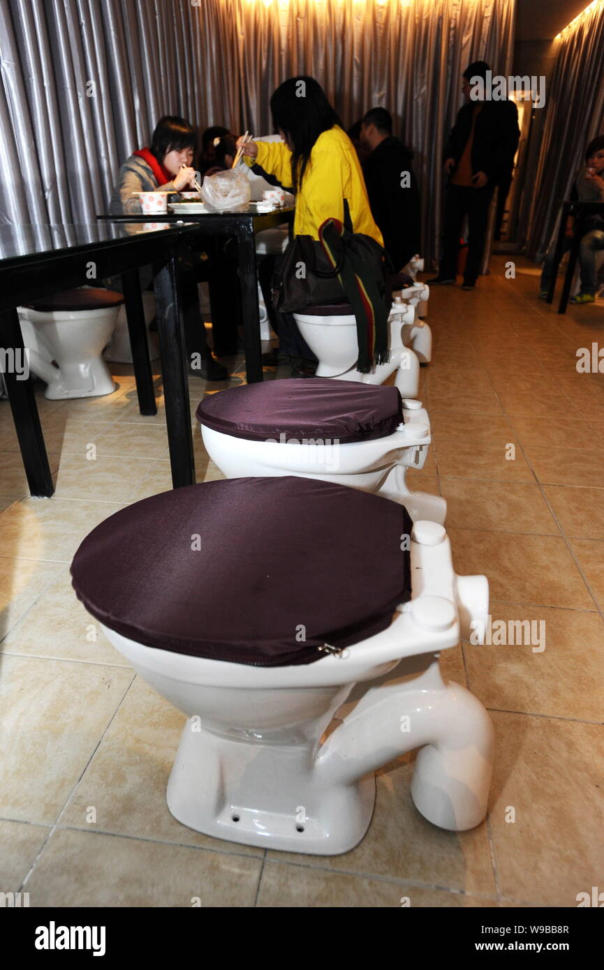 Chinese customers sitting on toilets eat barbecue at a toilet-themed ...