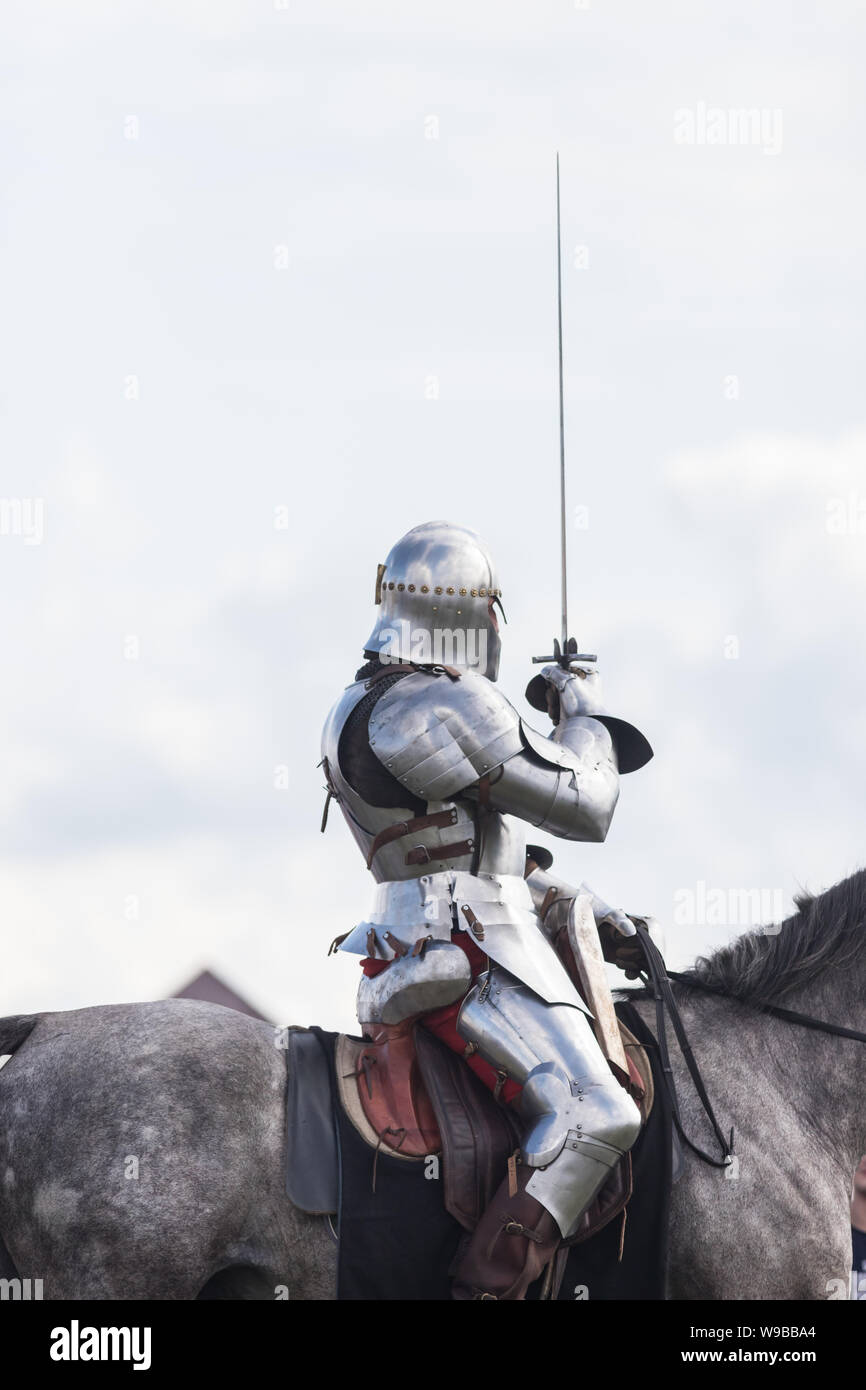 A man knight riding a horse holding a sword Stock Photo - Alamy