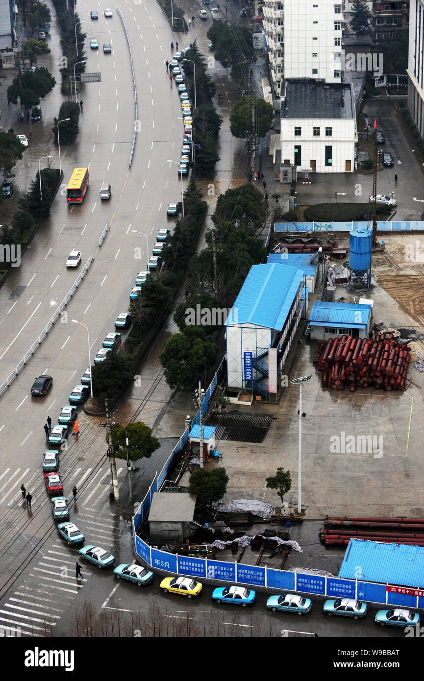 Aerial view of a long queue of taxis waiting to be refueled with ...