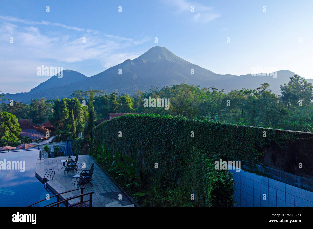 Mount Penanggungan view behind the pool Stock Photo - Alamy