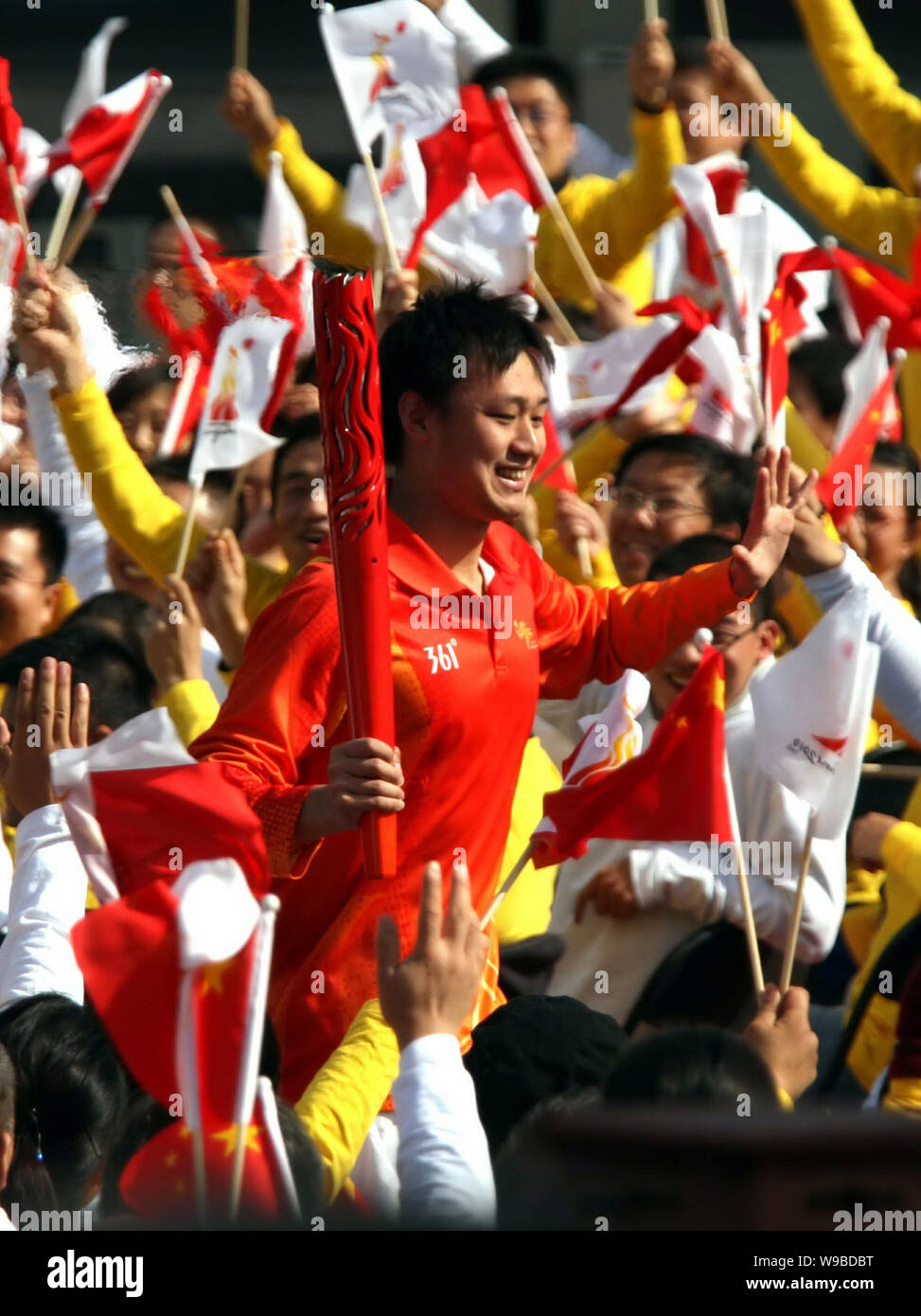 Chinese swimming world champion Zhang Lin, the first torch bearer, runs ...