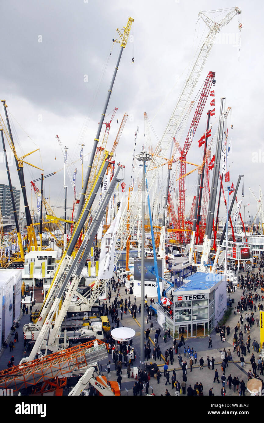 Visitors look at construction machineries during the 2010 International ...