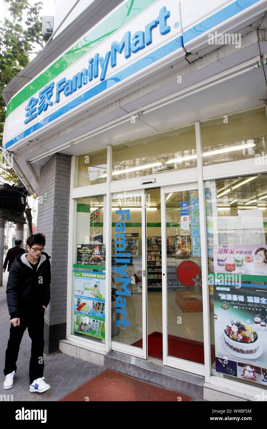 --FILE--A young man walks past a FamilyMart convenience store in ...