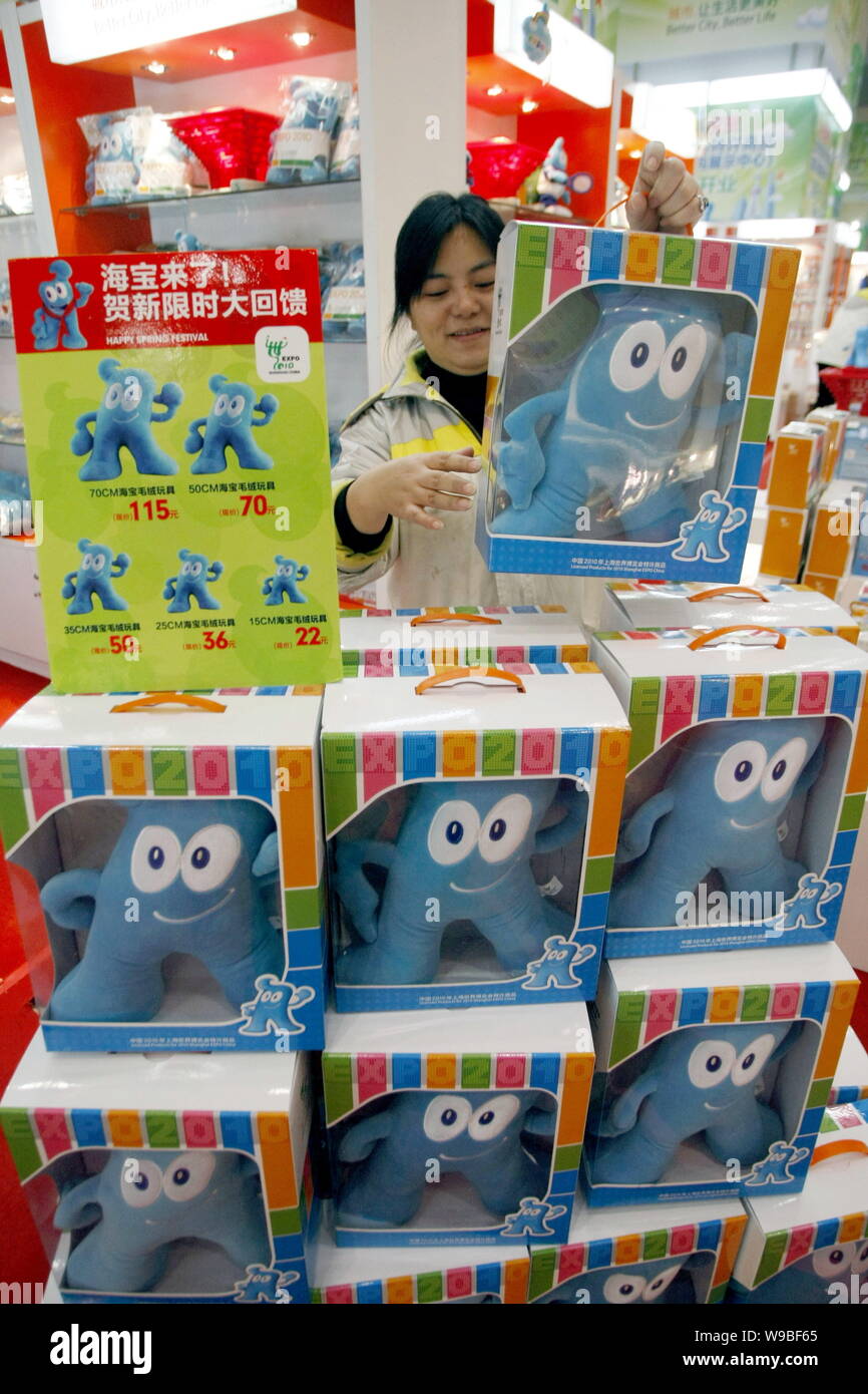 A Chinese employee arranges toys of Haibao, the official mascot of the ...