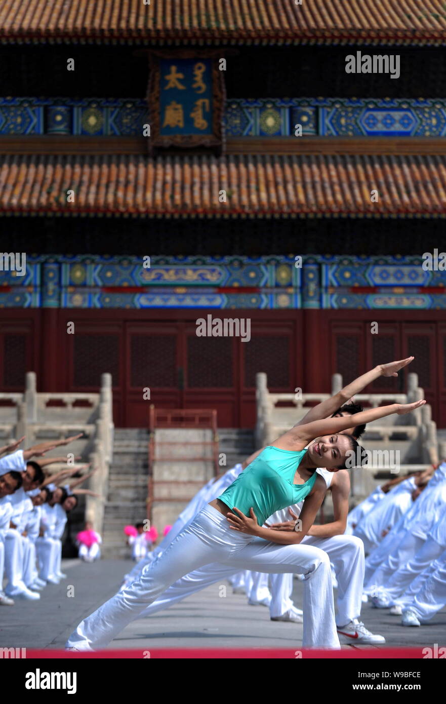Chinese participants do a synchronized physical exercise during a ...