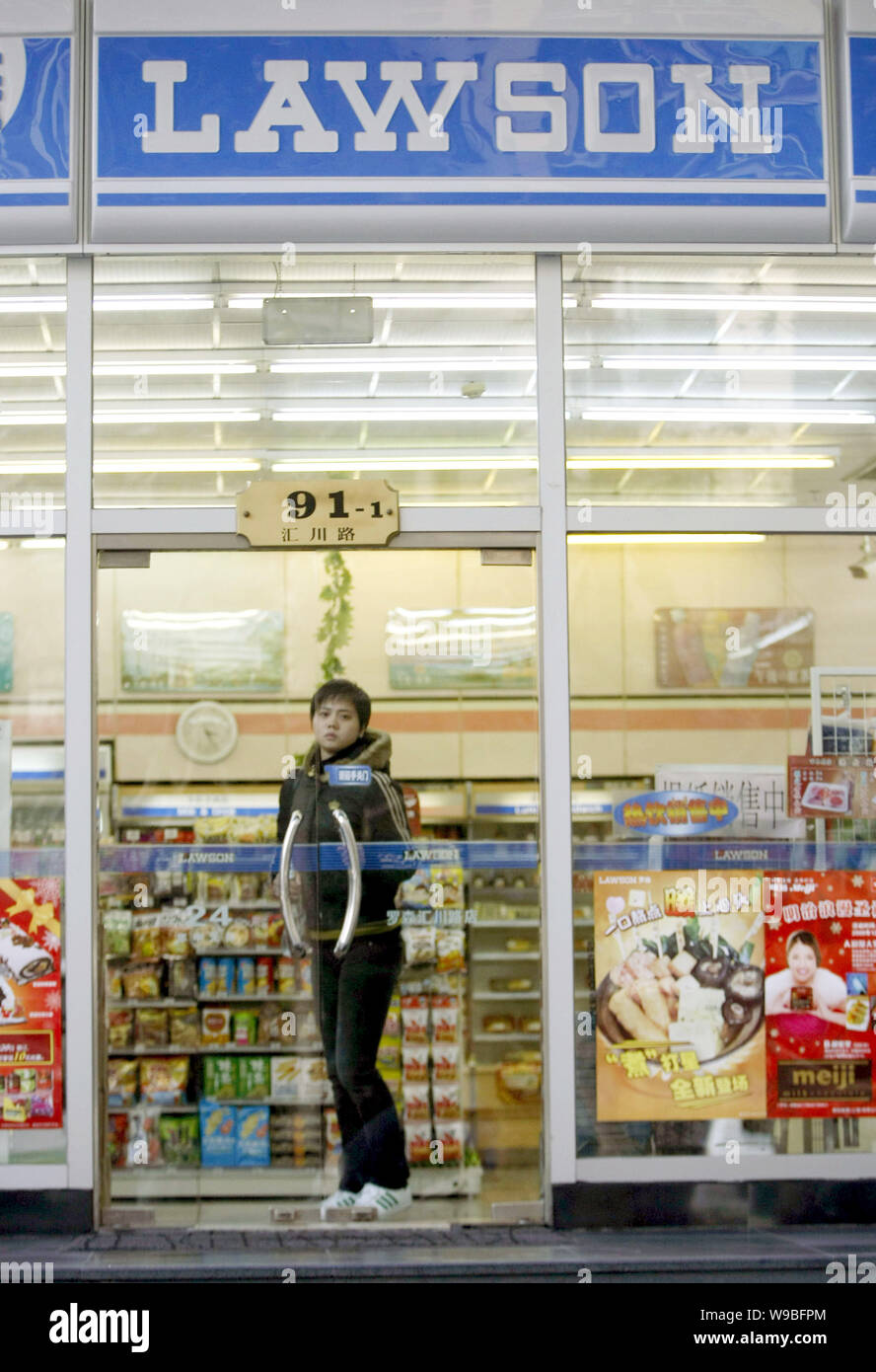 A Chinese customer walks out of a Lawson convenience store in Shanghai ...
