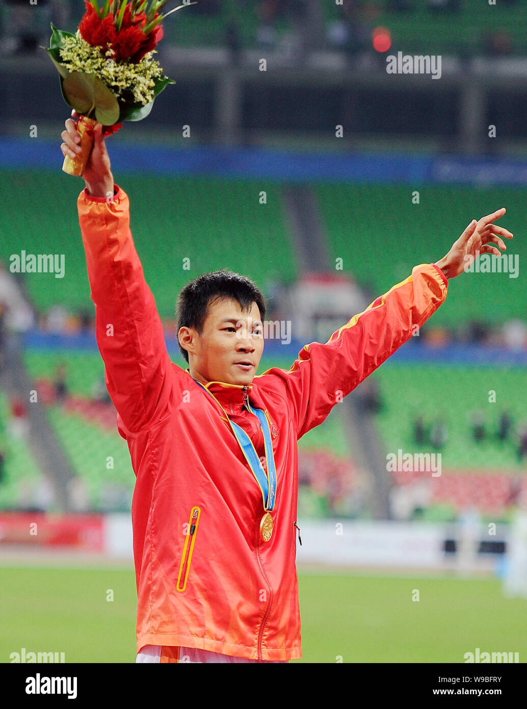Chinas Lao Yi celebrates his gold medal on the podium during the award ...