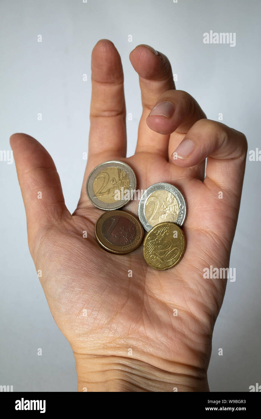 Euros in the hand, euro coins Stock Photo - Alamy