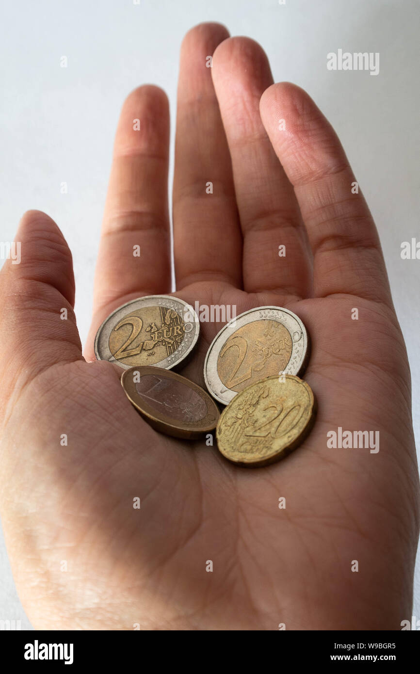 Euros in the hand, euro coins Stock Photo - Alamy