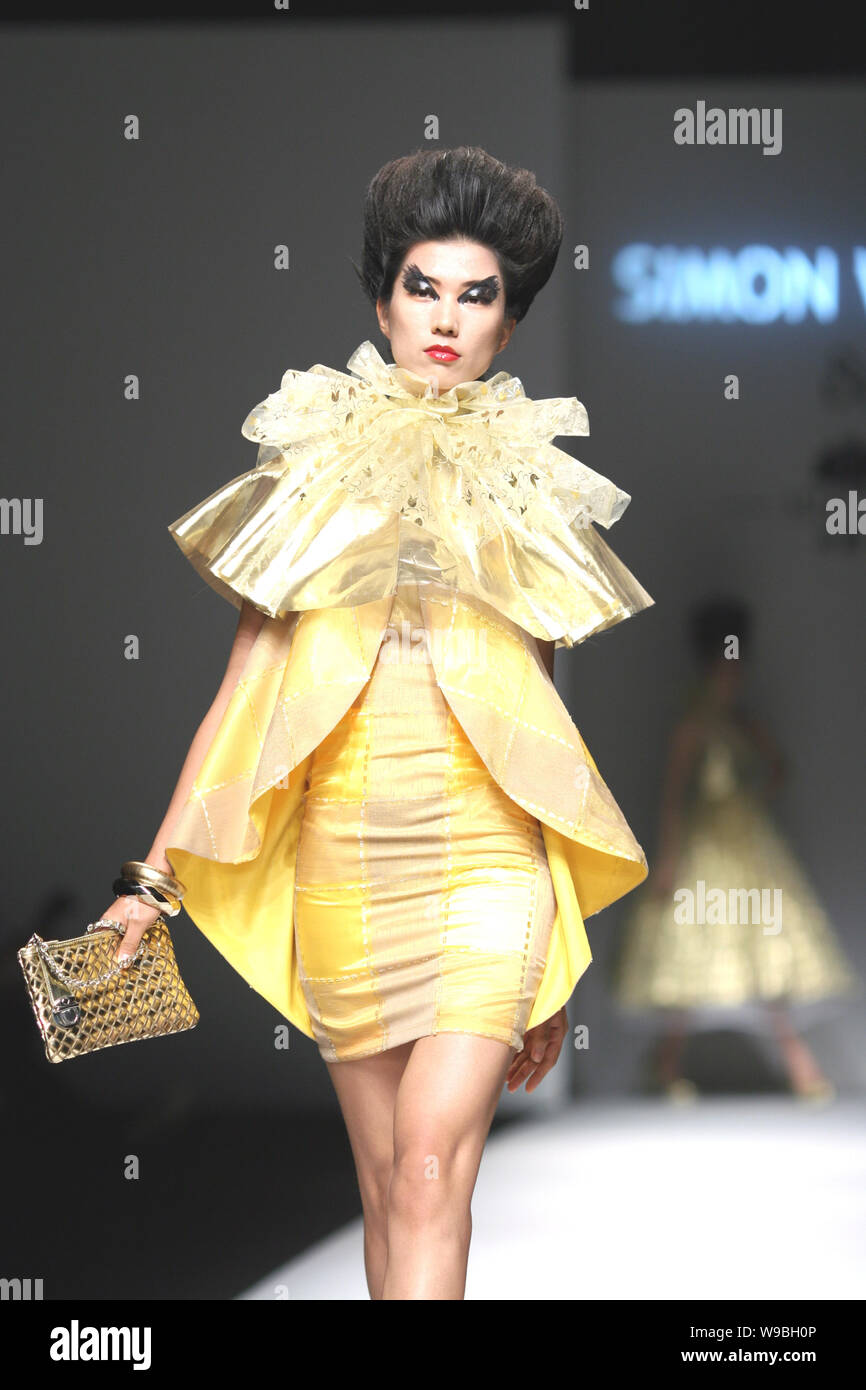 A model parades to show the new collections in the Simon Wang fashion ...
