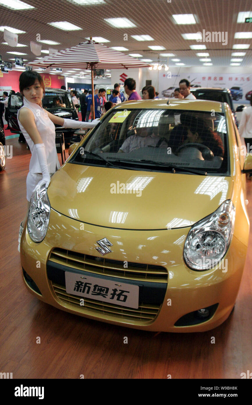 Chinese car buyers try a Changan Alto during an auto show in Haikou ...