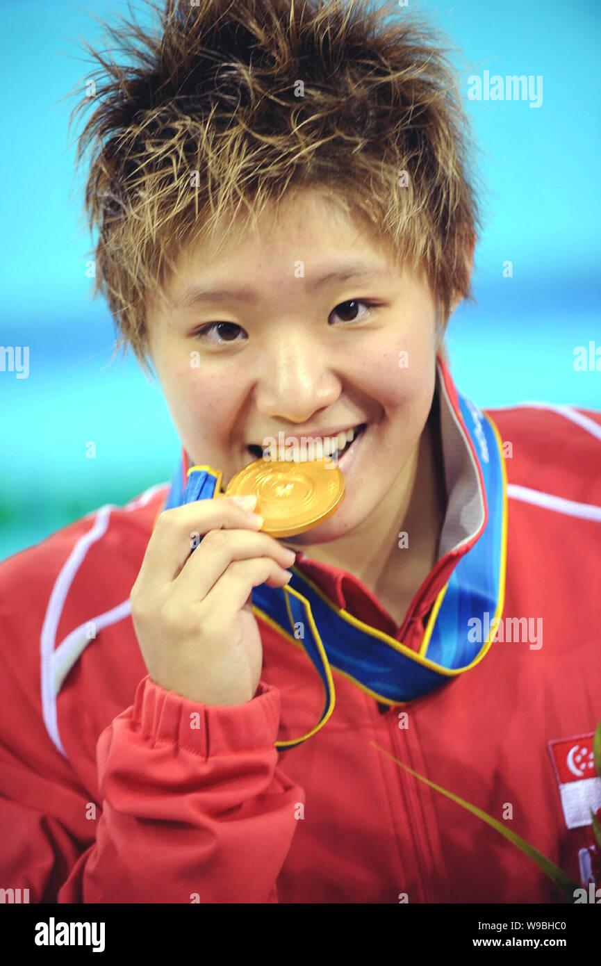 Tao Li of Singapore shows her gold medal during the award ceremony for ...