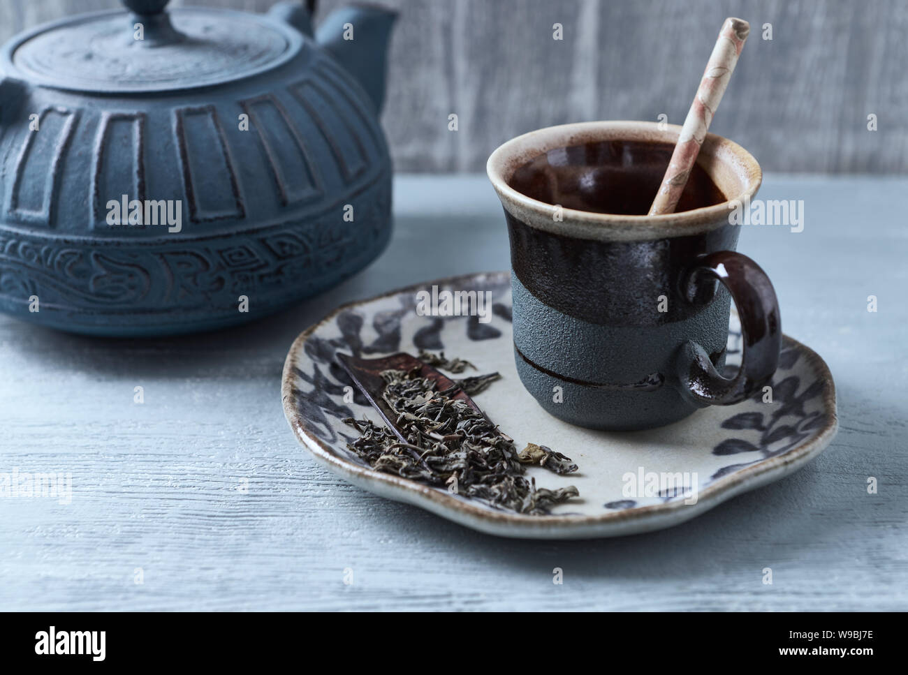 Empty Ceramic Tea Cup and Green Tea Leaves. Symbolic image. Asian ...