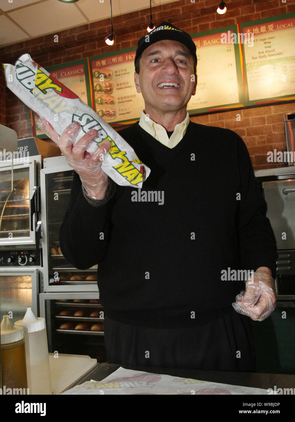 Fred DeLuca, President of Subway, shows a sandwich at a Subway ...