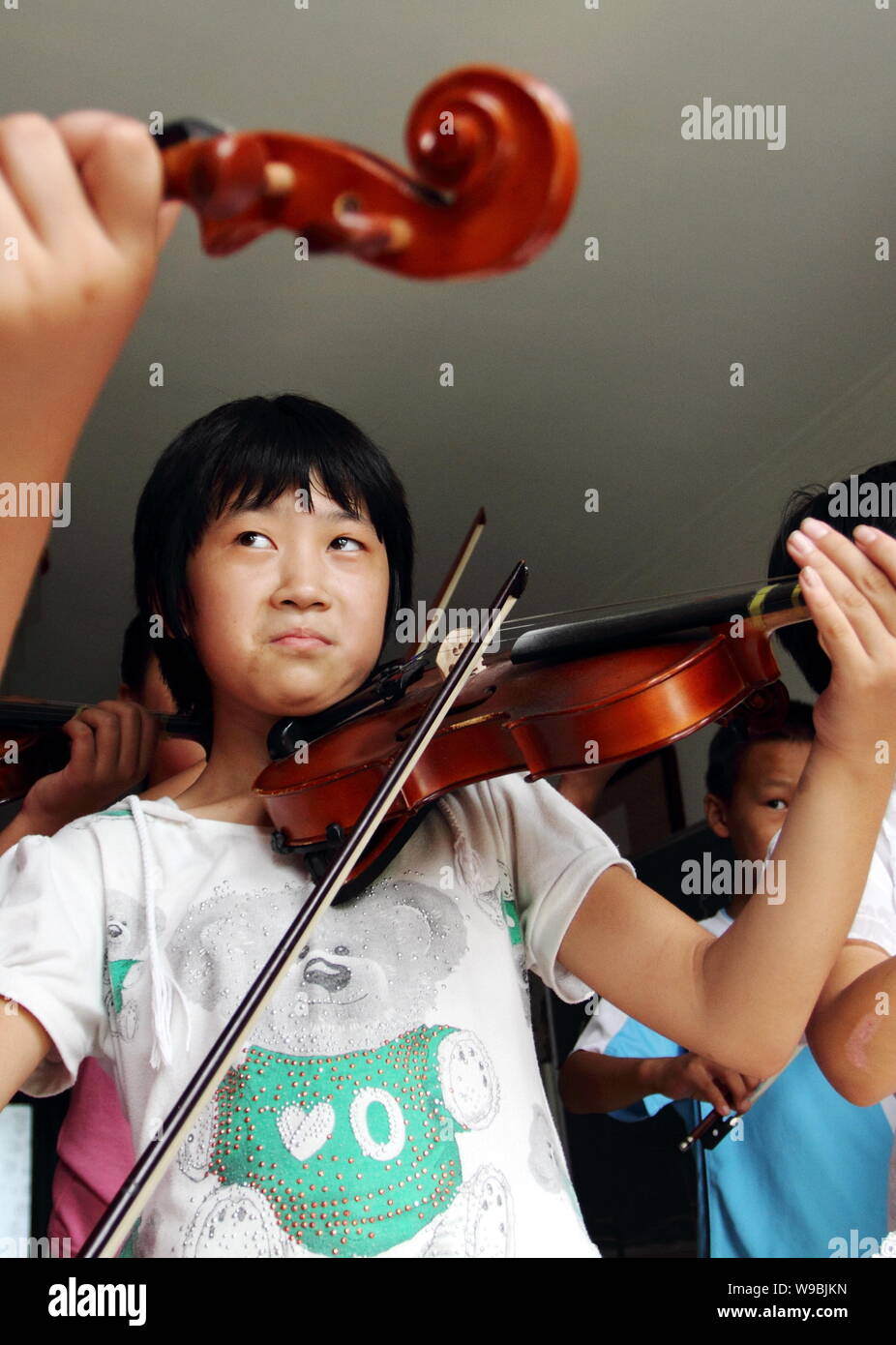 Chinese kids playing musical instrument hi-res stock photography and ...