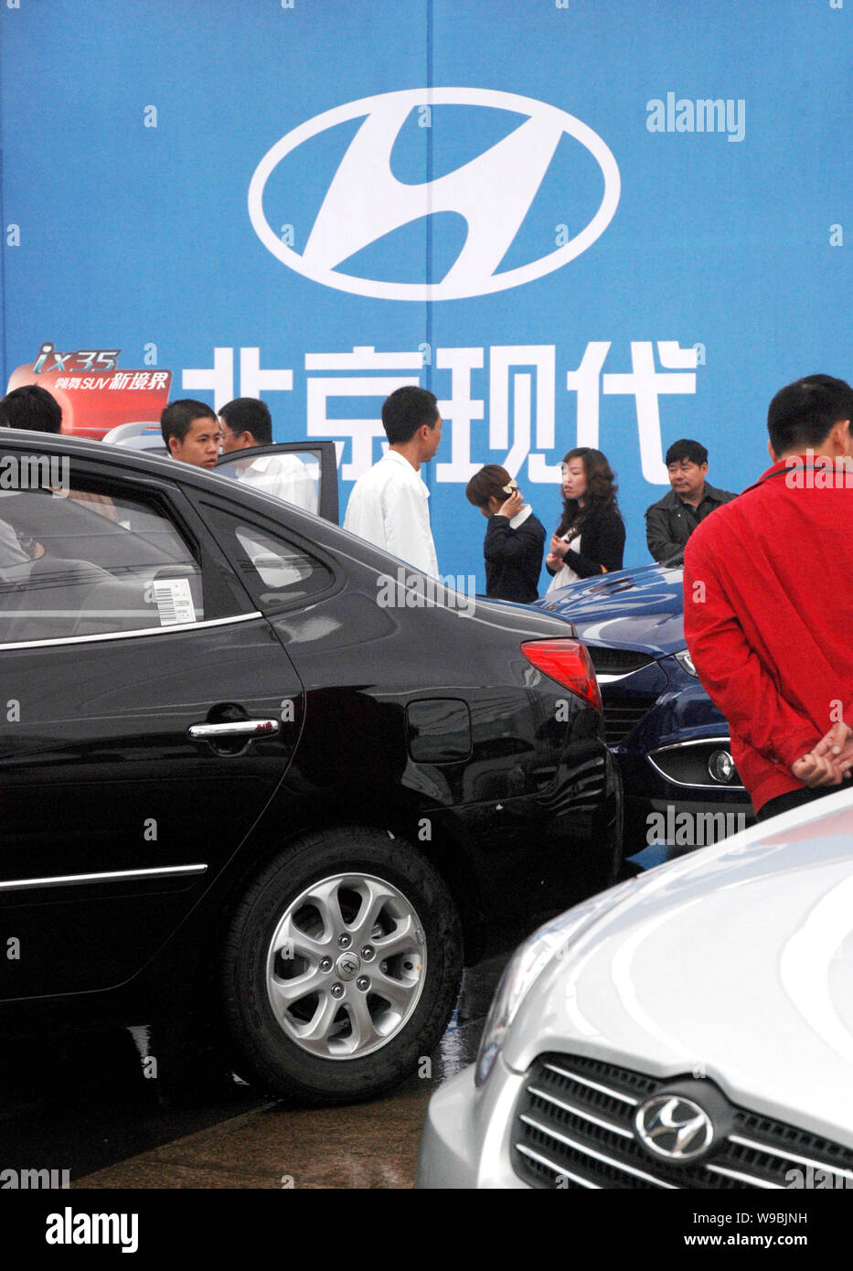 --FILE--Chinese car buyers look at Hyundai cars during an auto show in ...