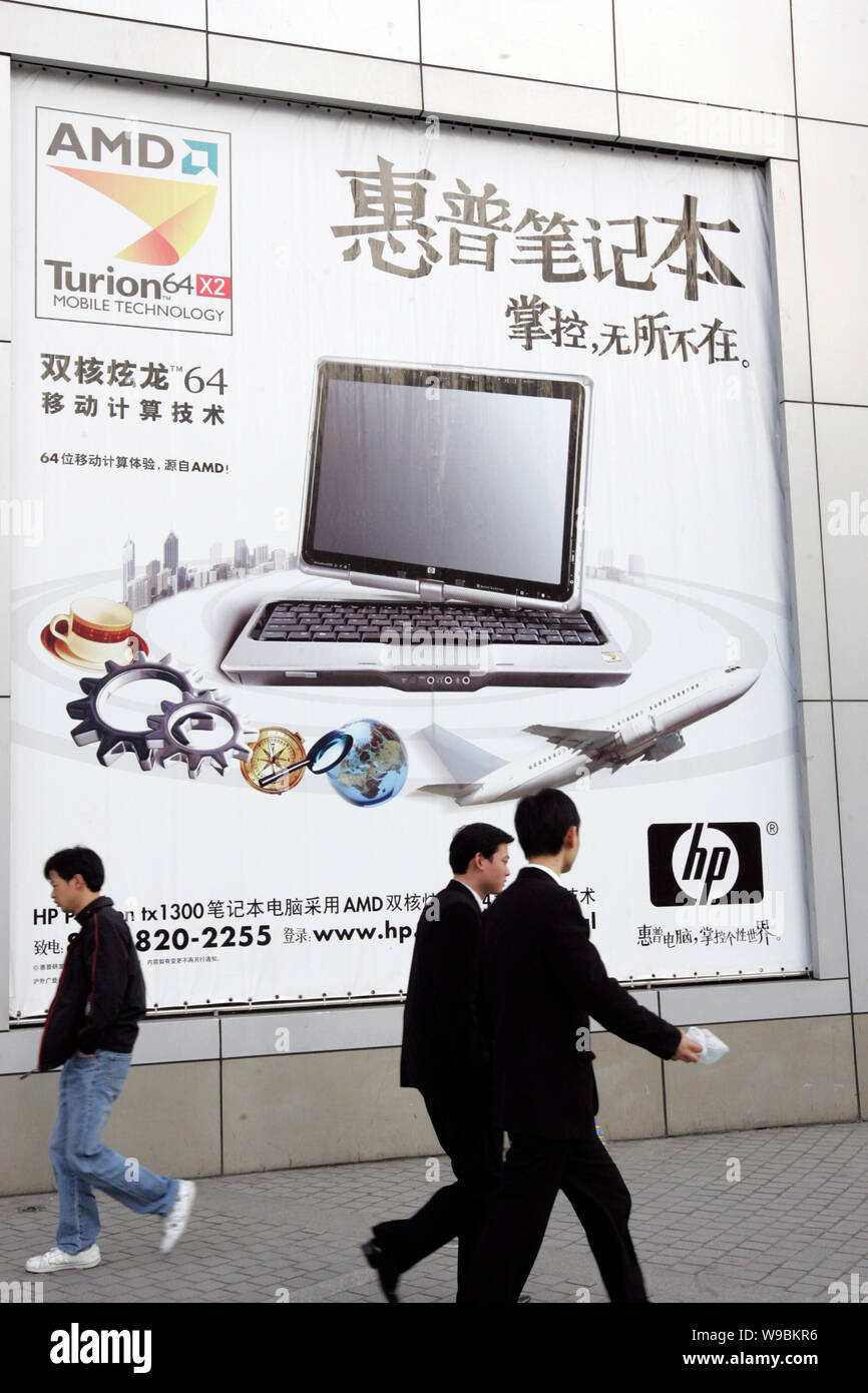 --FILE-- Local residents walk past an advertisement of HP (Hewlett ...