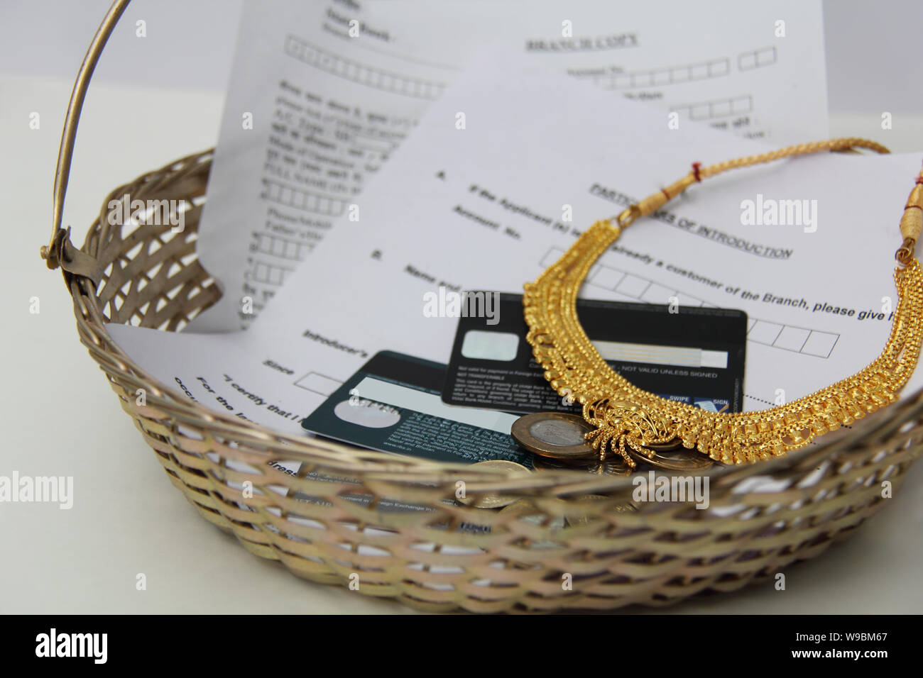 Gold necklace and credit cards in a basket Stock Photo - Alamy
