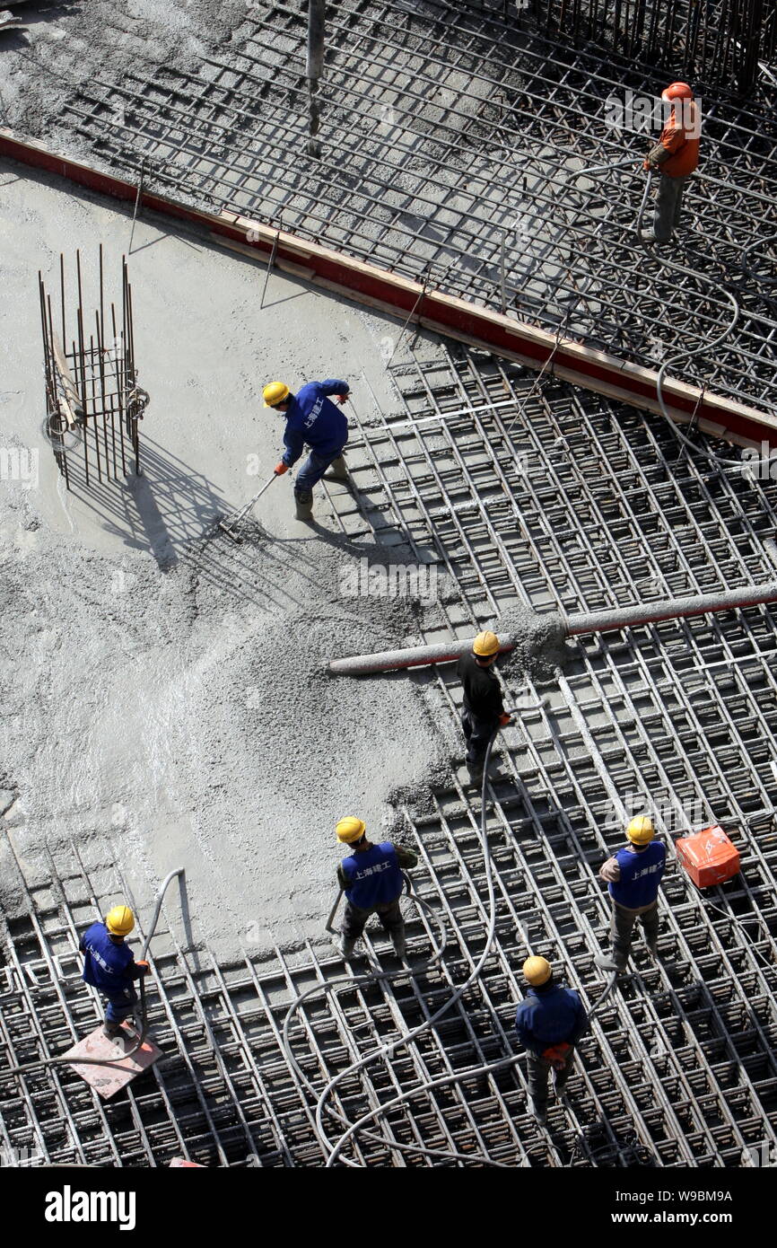 Chinese construction workers concrete the foundation of the Shanghai ...