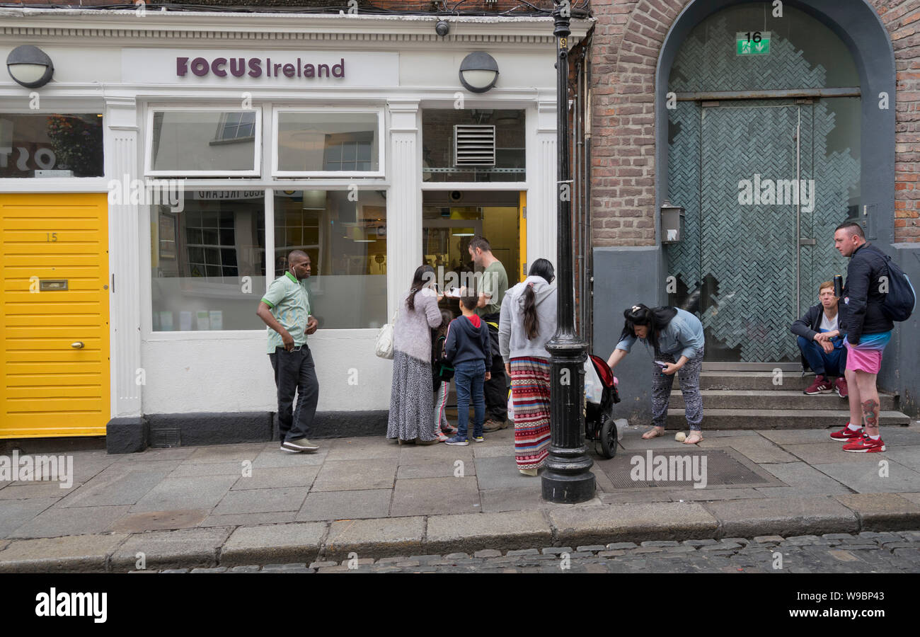 Homeless people and refugees in line to receive support from a charity ...