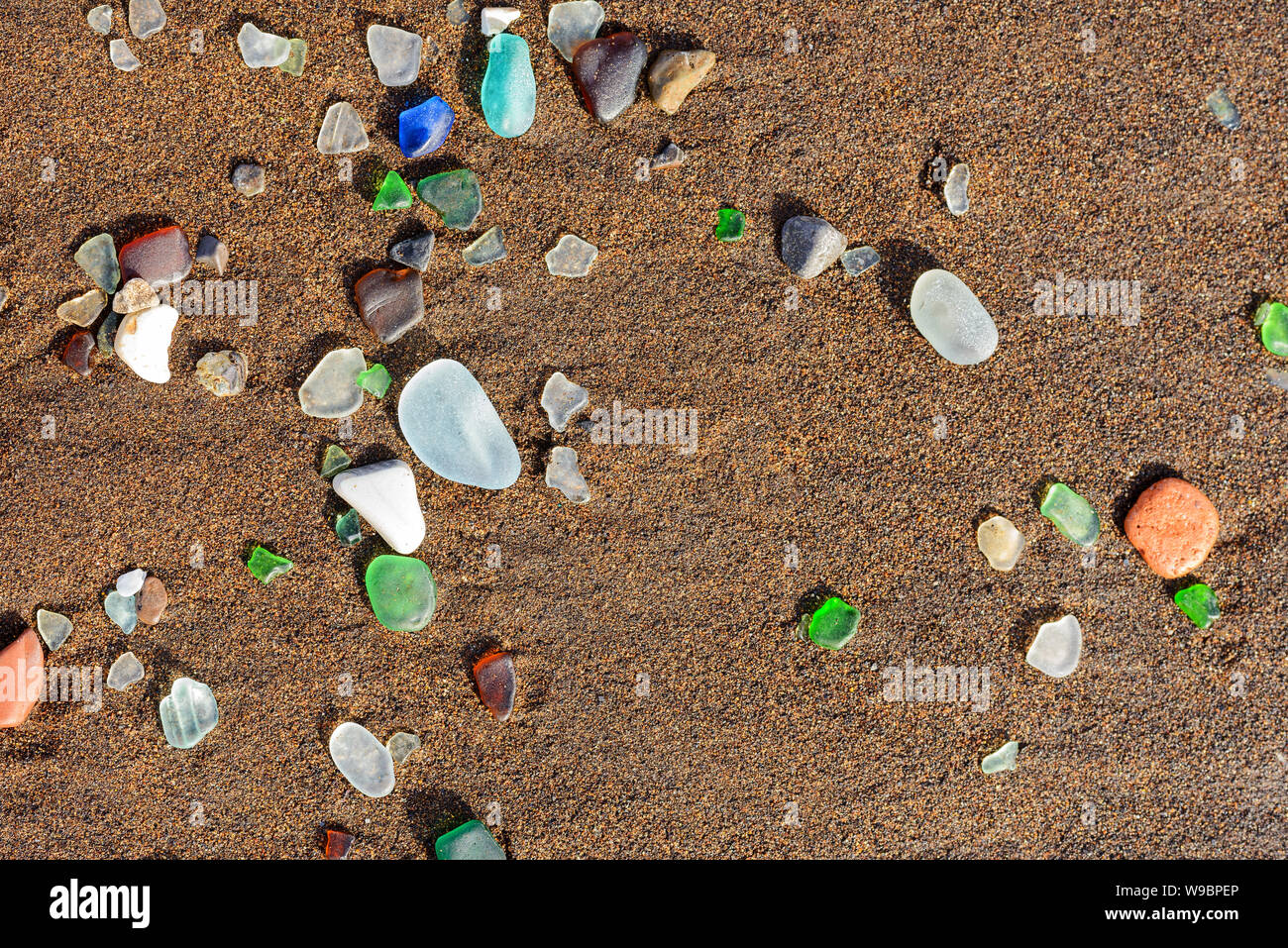 Glass pebble on sand Stock Photo - Alamy