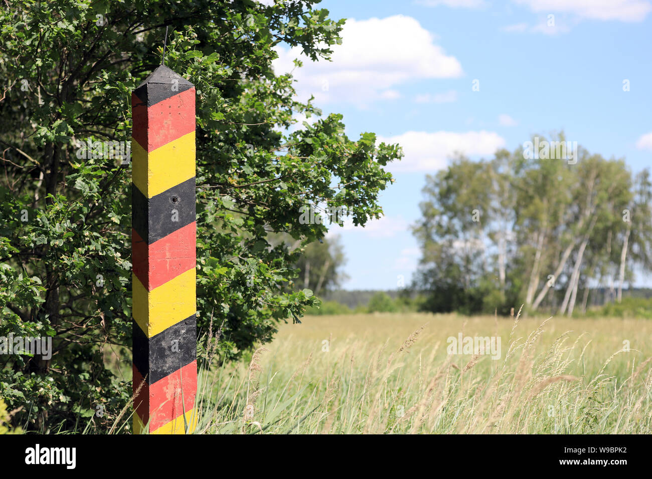 Arendsee, Germany. 09th June, 2019. A black-red-golden boundary stone ...