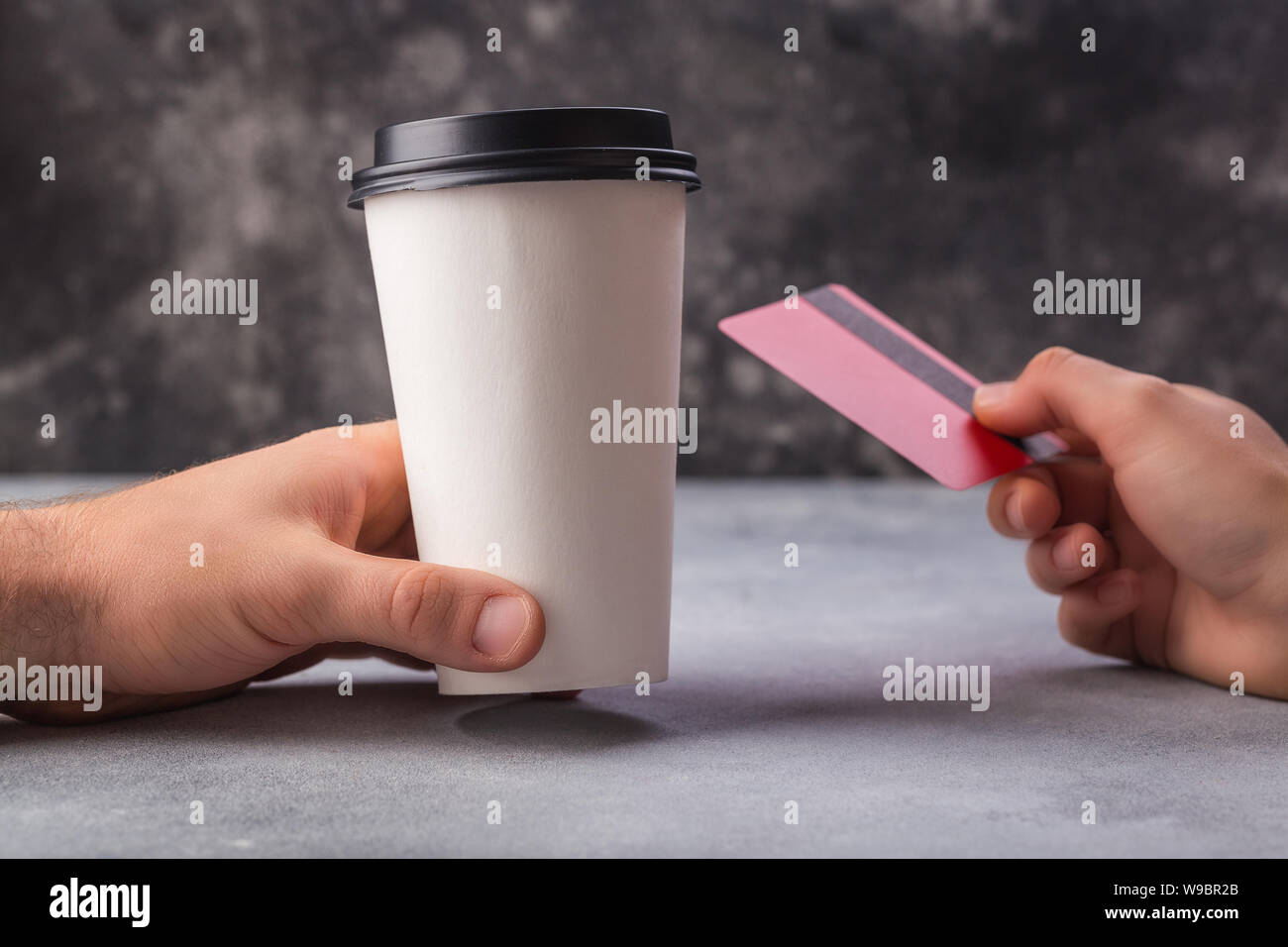 Paying for coffee by credit card minimalism woman and man hands grey ...