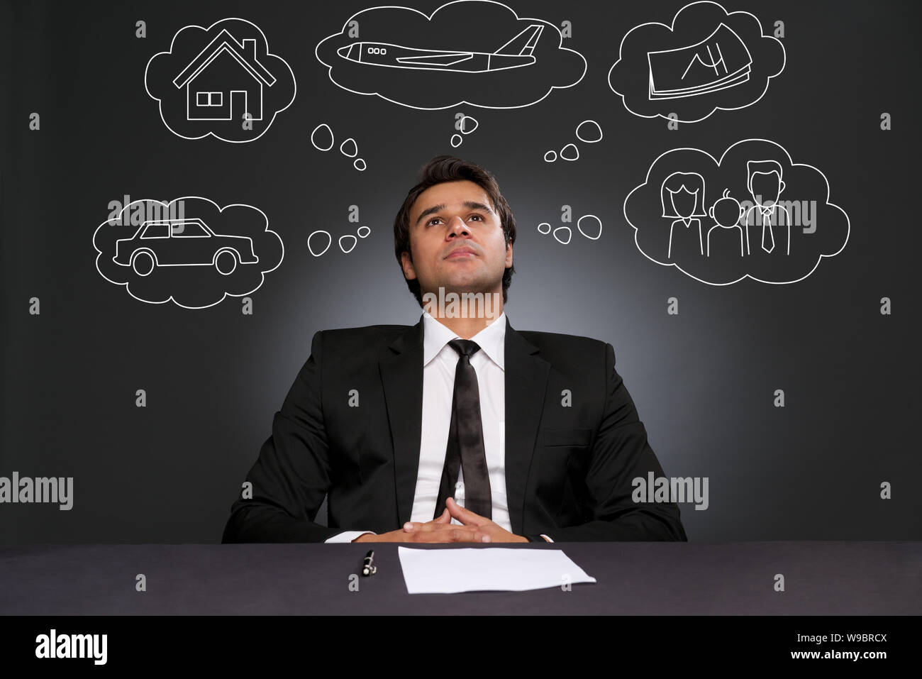 Businessman with multiple thoughts in bubbles Stock Photo - Alamy