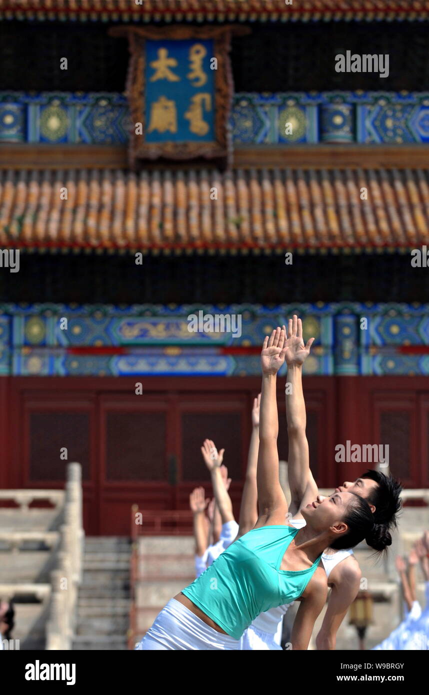 Chinese participants do a synchronized physical exercise during a ...