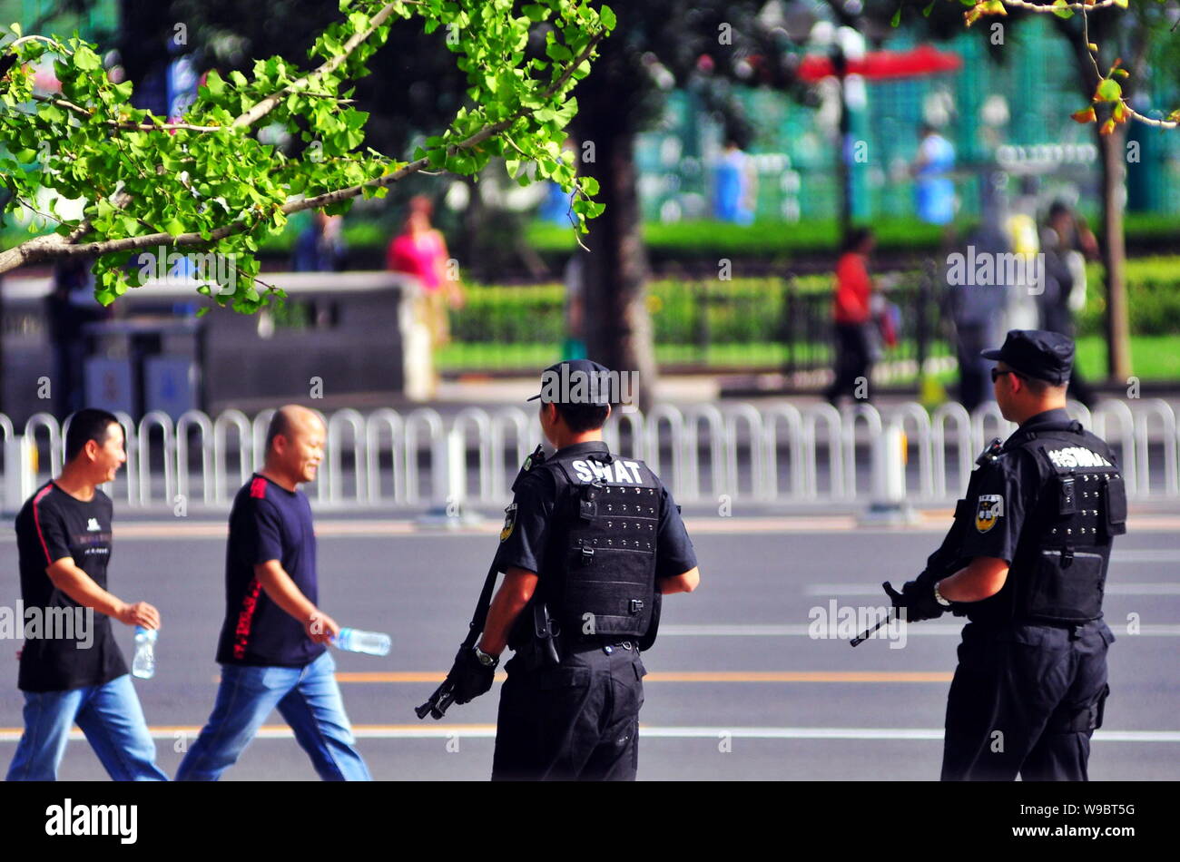 Armed Chinese special policemen patrol a street in Beijing, China, 12 ...