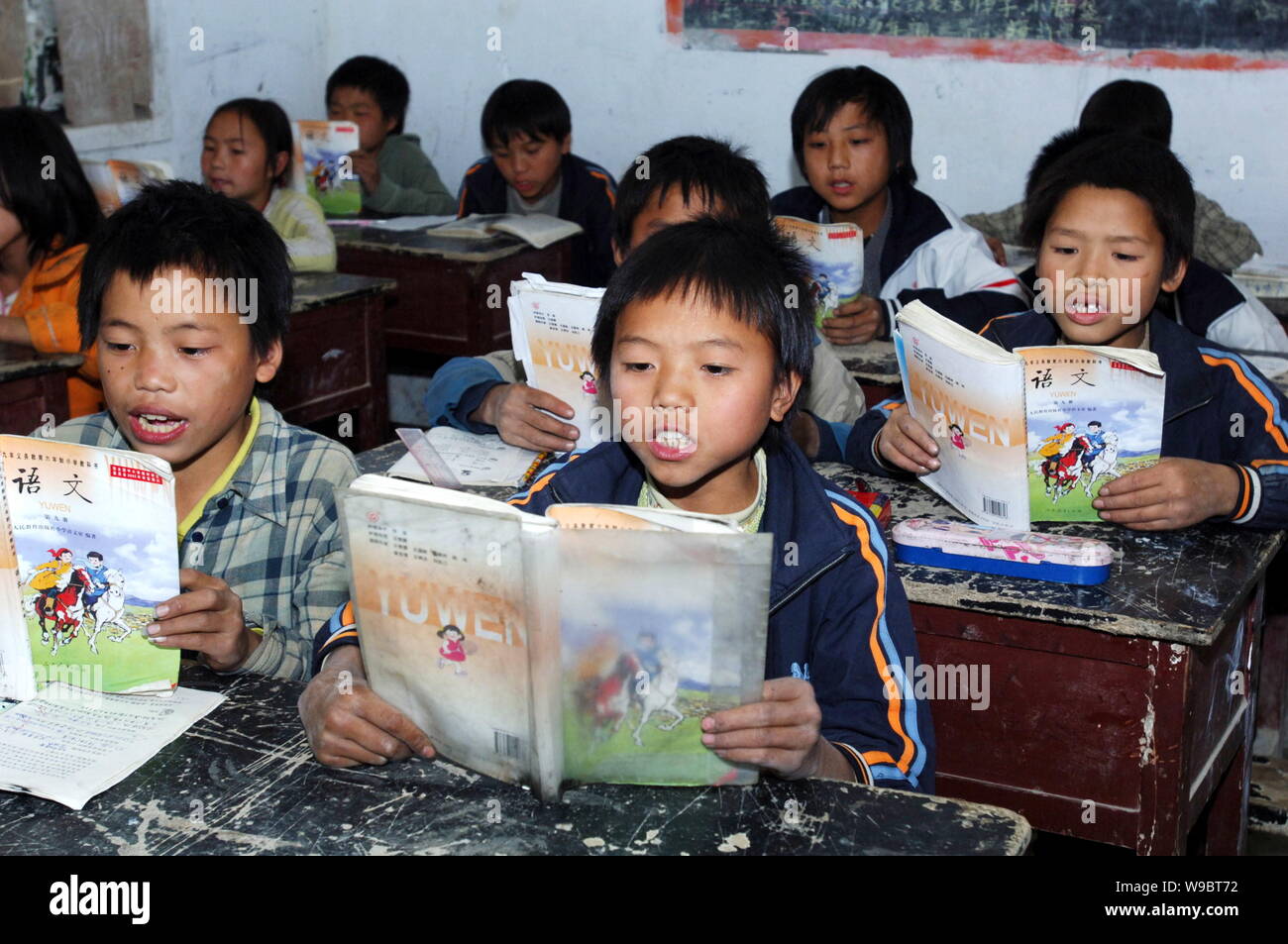 Chinese pupils read their textbooks during a class at the Zhongdong ...