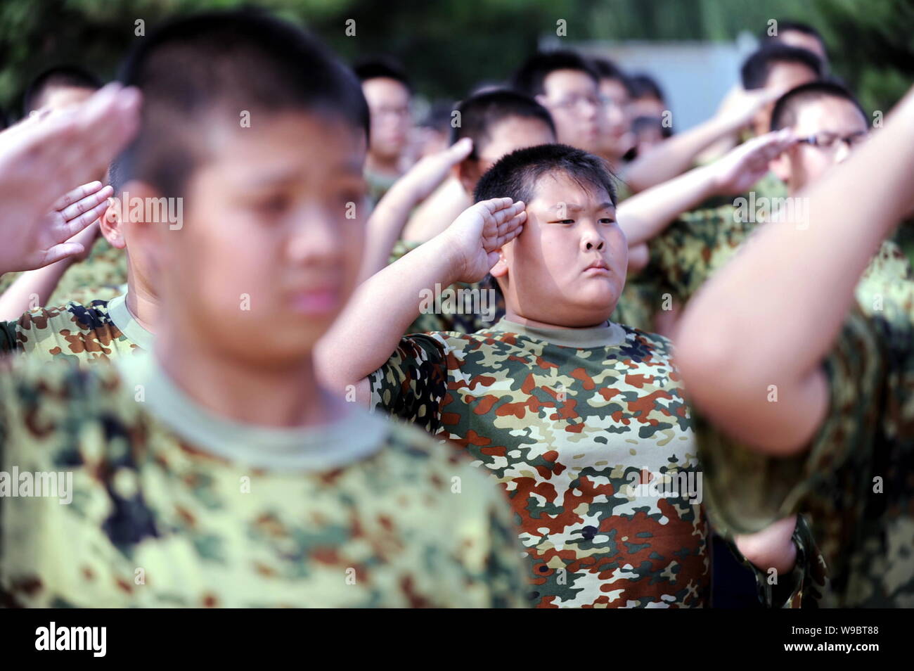 Obese Chinese children salute at an exercise during a military training ...