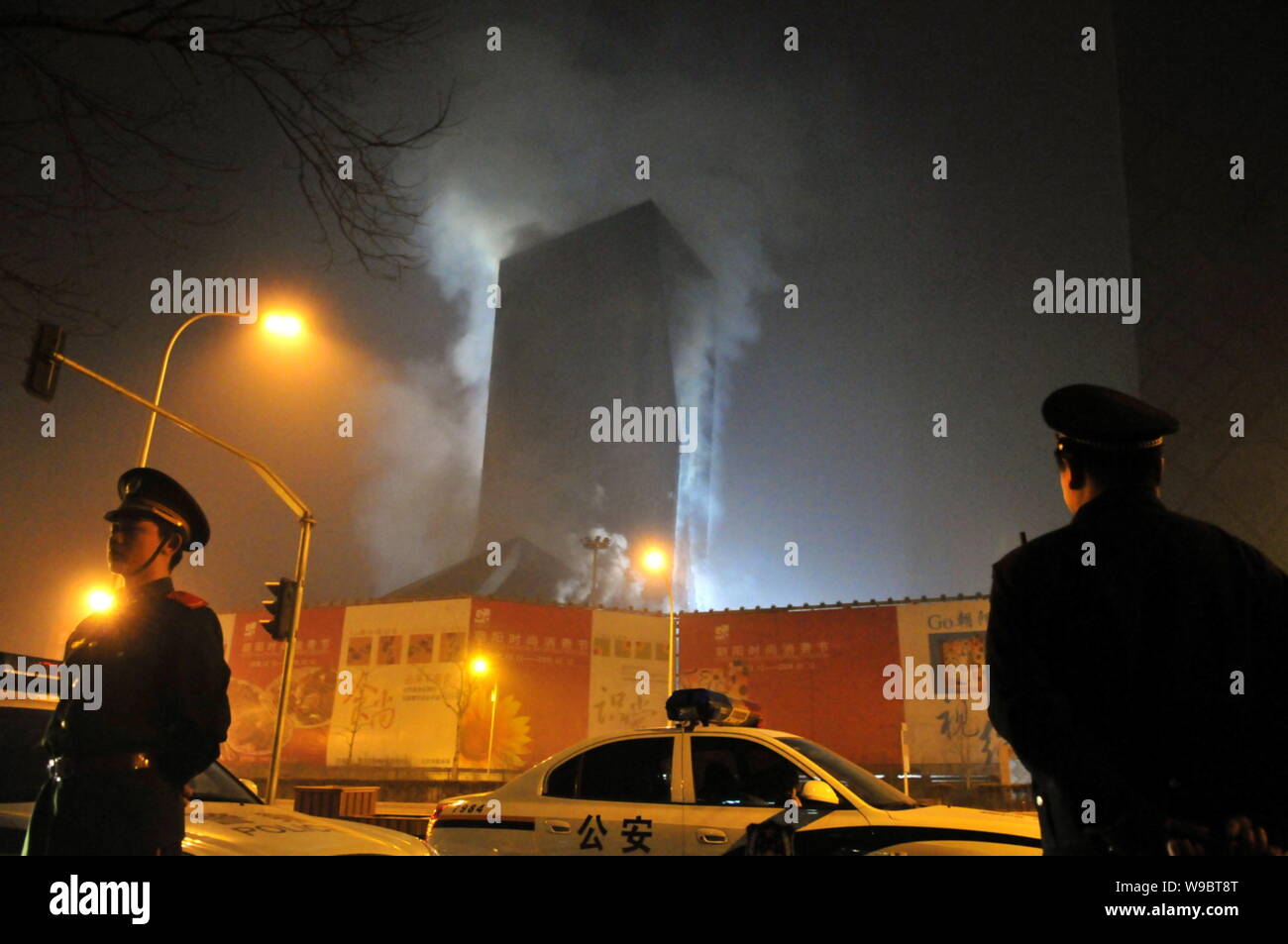 A police officer, right, and a paramilitary policeman stand guard in ...