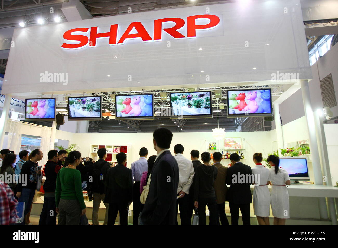--FILE-- Visitors look at Sharp LCD televisions at an exhibition in ...