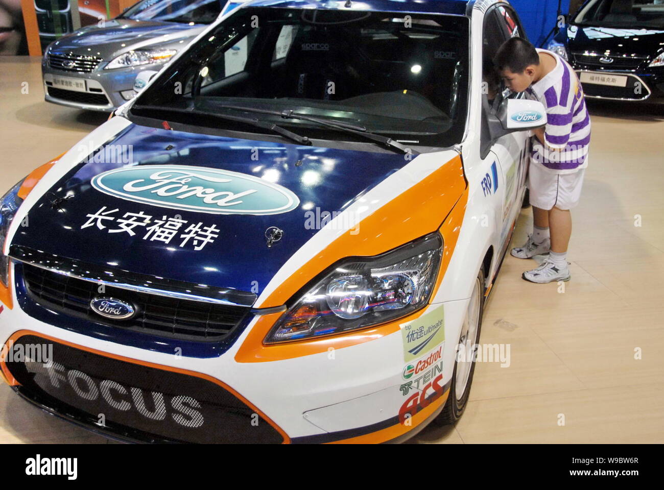 --FILE--A Chinese boy looks at a Ford Focus, manufactured by ChangAn ...