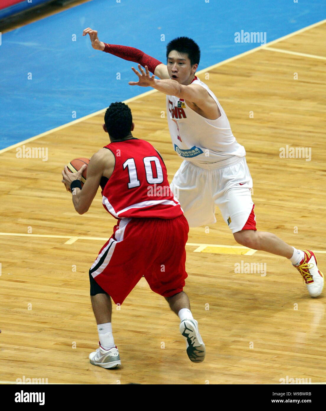 Chinas Sun Yue, back, tries to block a shot by Osama Daghles of Jordan ...