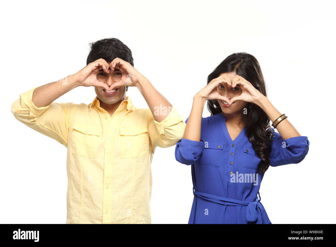 Woman smiling making love hand Cut Out Stock Images & Pictures - Alamy