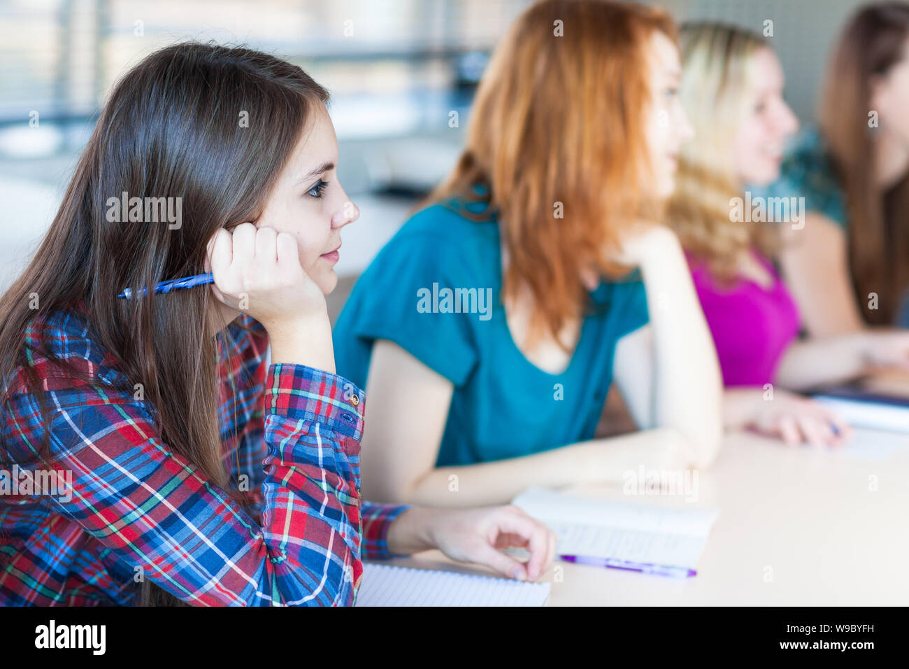 Students in classroom - young pretty female college student sitting in ...