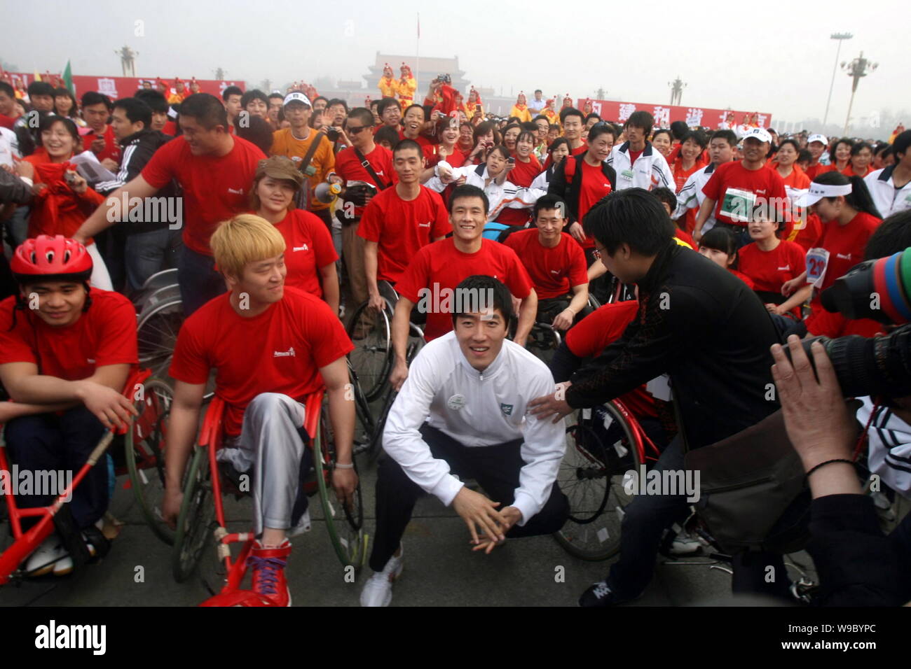 Chinese star hurdler Liu Xiang, middle, poses with disabled ...