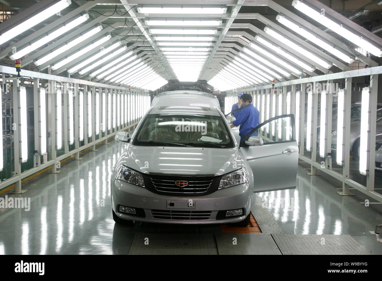 Chinese factory workers check Geely Emgrand EC718 cars on the ...